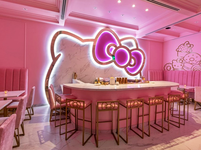 The bow-shaped bar glows like a beacon of pink possibility. If James Bond ordered a cocktail here, it would definitely come with a tiny umbrella.