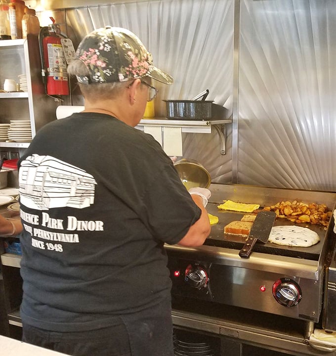Where the magic happens&mdash;a short-order cook orchestrating breakfast symphonies on a well-seasoned griddle.