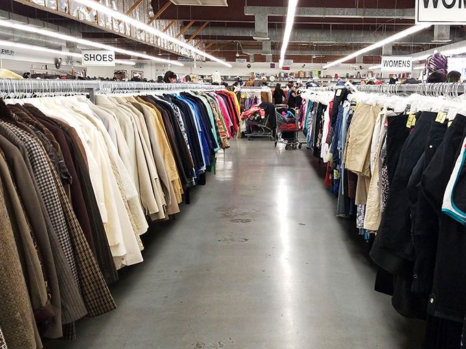 A rainbow of possibilities hanging in perfect formation. Someone's discarded blazer is about to become someone else's signature look.