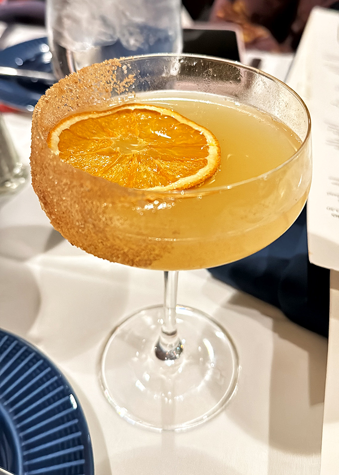 A cocktail with a sugar-rimmed edge and orange slice garnish&mdash;because sometimes your lobster needs a sophisticated sidekick.