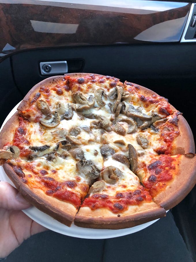 This mushroom pizza, enjoyed in the comfort of your car, proves that simple pleasures are often the most satisfying.