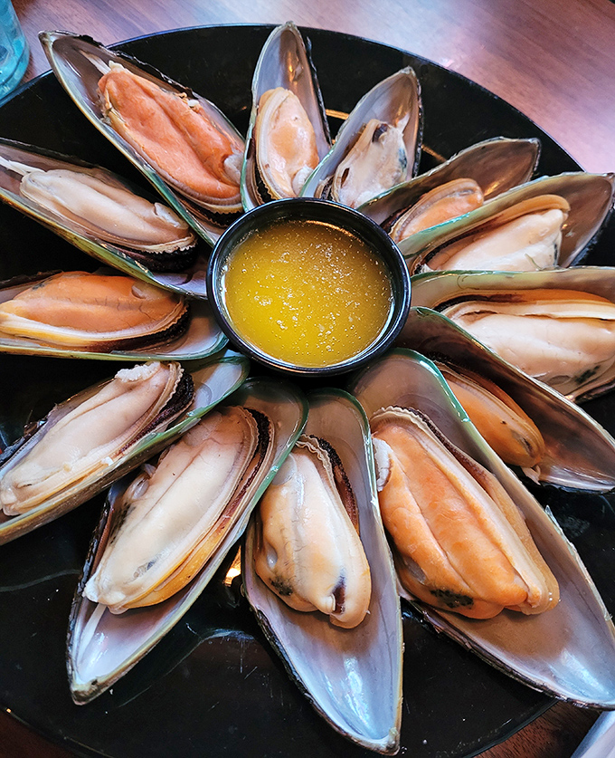 These mussels aren't just seafood; they're little ocean jewels arranged in a perfect circle, like Neptune's own dinner party.