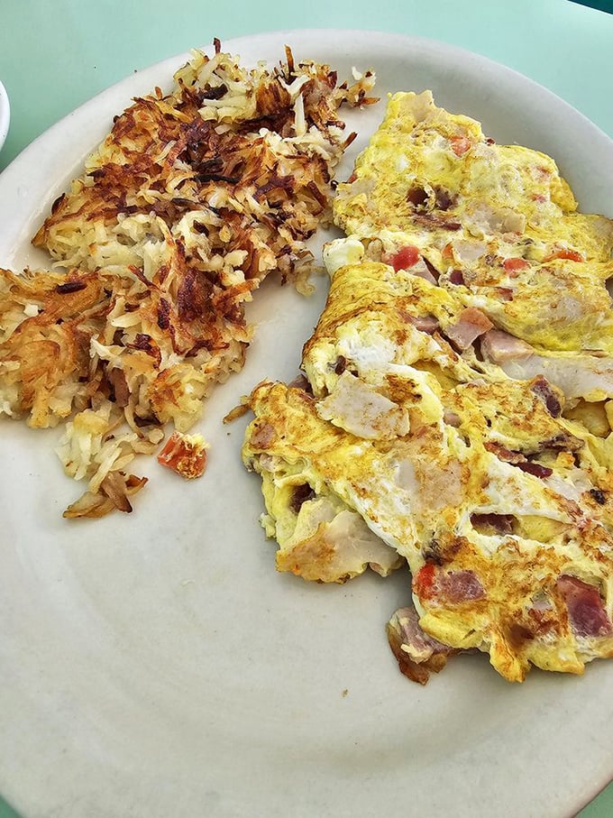 An omelet that's seen things&mdash;namely cheese, ham, and vegetables. Its crispy hash brown companion is equally impressive.
