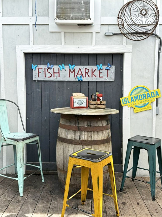 A fish market sign, colorful stools, and a barrel table—nautical charm so authentic you'll check your pockets for sand.
