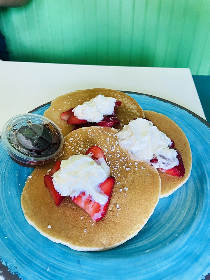 These pancakes aren't just breakfast&mdash;they're a pillowy canvas for fresh strawberries and whipped cream. Morning indulgence that feels like getting away with something.