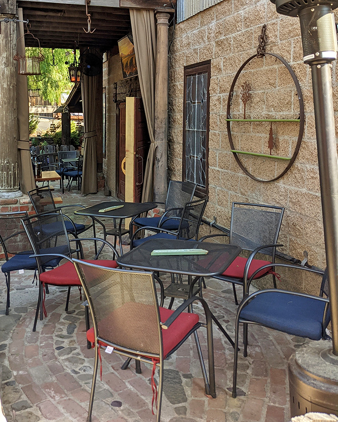 These patio tables have witnessed countless first dates, anniversary celebrations, and "just because" meals. The stone walls and rustic charm create California's coziest outdoor dining room.