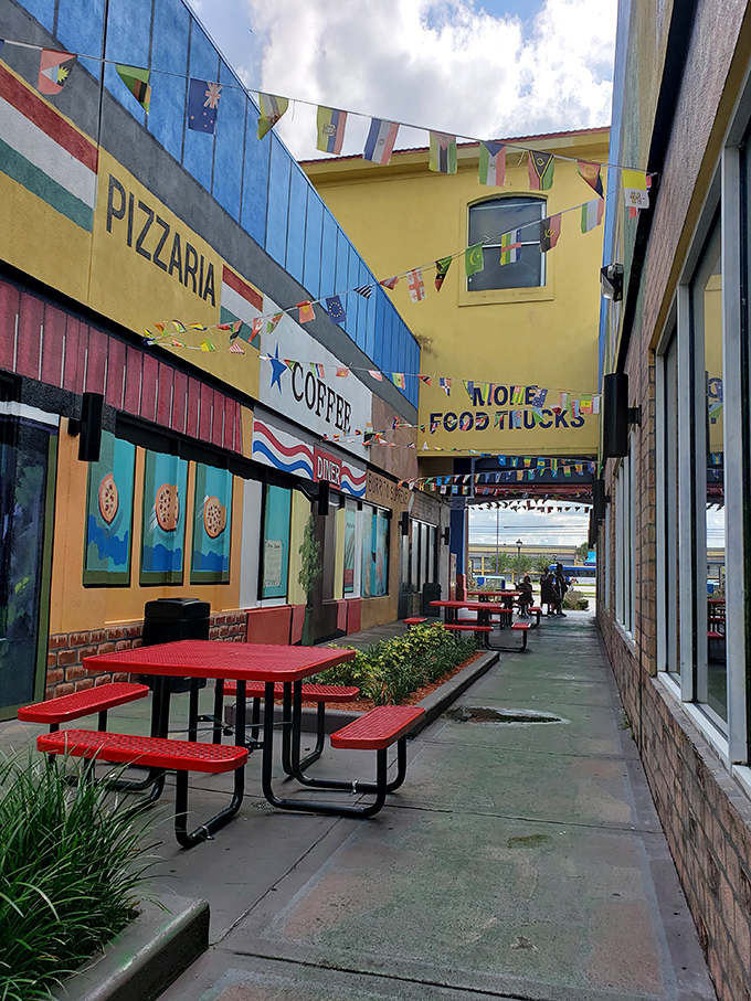 The market's outdoor dining area offers a festive respite with international flags fluttering overhead like a United Nations of flavor. 