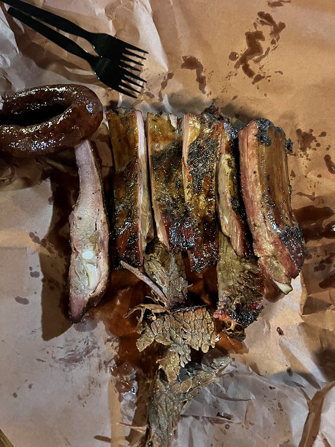 These ribs and sausage aren't just food; they're edible evidence that patience and wood smoke can transform the ordinary into art.