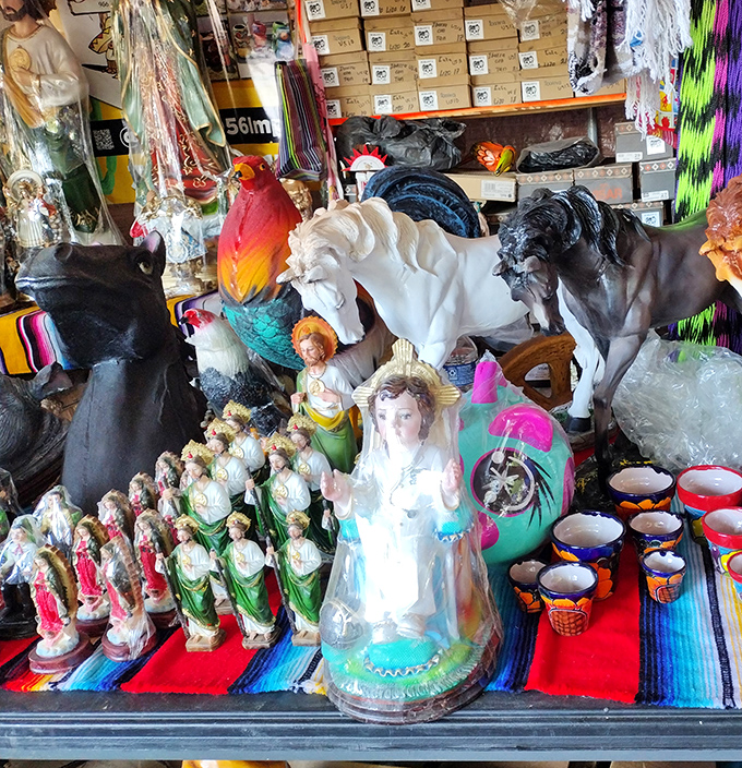 Religious figurines and decorative horses stand in silent formation, waiting for the right person to give them a place of honor in a new home.