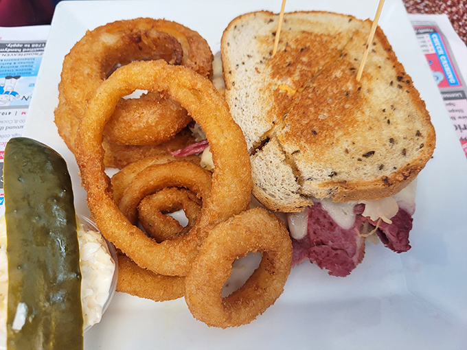 The Reuben sandwich&mdash;where corned beef meets sauerkraut in a dance as old as time, with those onion rings playing perfect wingman.