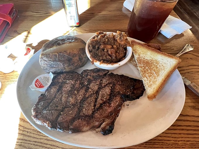 A ribeye that makes you wonder why you ever bothered with those fancy steakhouses. That baked potato is practically begging for attention too.