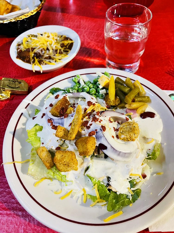 A salad that knows its role—setting the stage for the main event while still bringing its A-game with bacon bits and cheese.