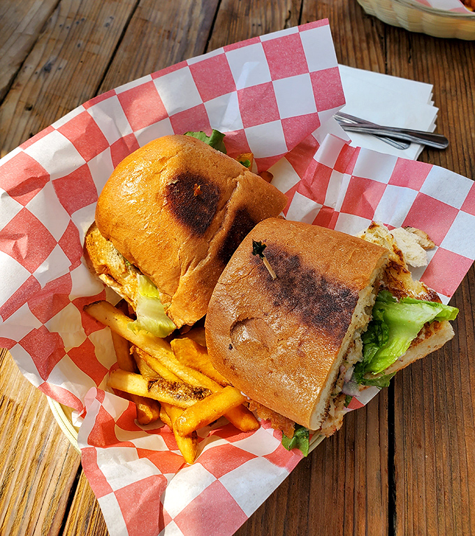 A sandwich that requires both hands and several napkins – the hallmark of coastal eating done right. Those fries aren't just a side, they're co-stars.