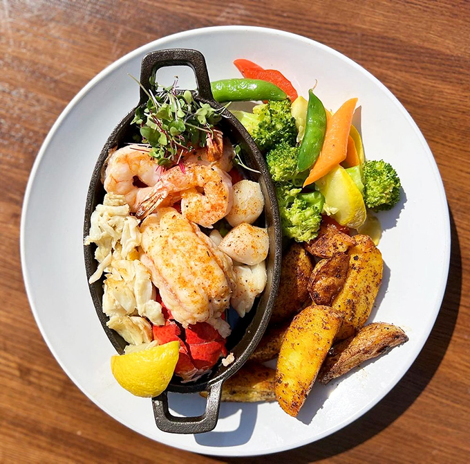 The seafood platter that dreams are made of—tender shrimp, flaky fish, and perfectly cooked scallops served with seasonal vegetables and potatoes.