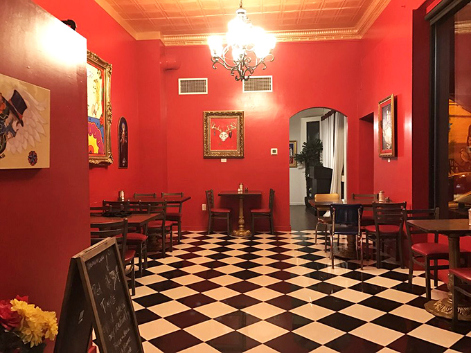The checkered floor and crimson walls create a dining room that feels both retro and timeless, like stepping into a delicious time warp.