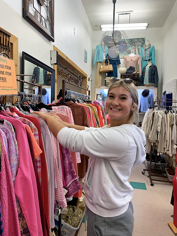 The joy of discovery captured in a single smile &ndash; this shopper just found that perfect piece that makes thrifting an addictive treasure hunt.