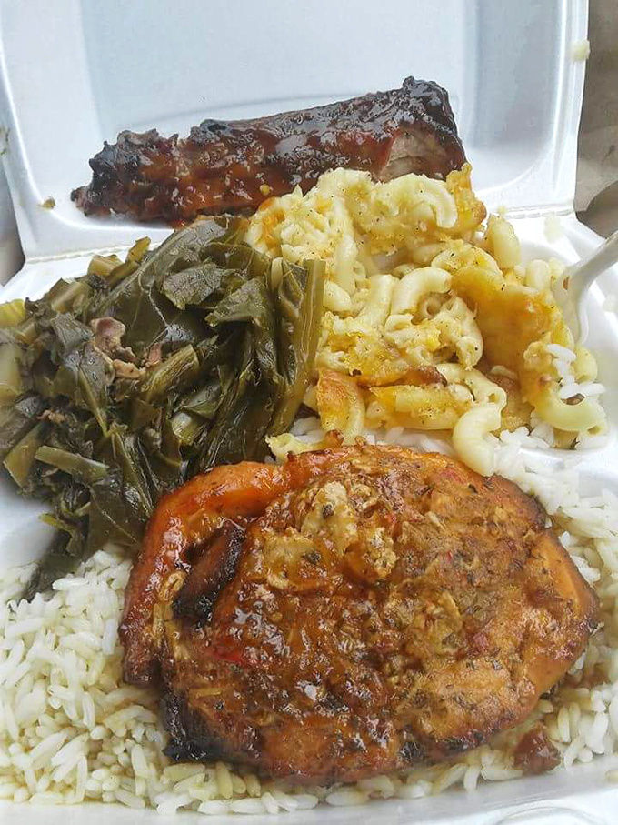 Soul on a plate: perfectly seasoned meat, rice, greens, and mac and cheese. The kind of meal that makes you close your eyes on the first bite.