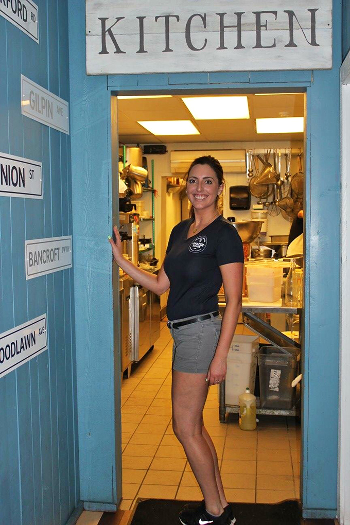 The kitchen entrance, adorned with street signs, offers a glimpse into the heart of the operation where seafood magic happens daily.