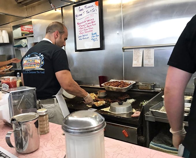 Behind every great breakfast is someone who understands the sacred geometry of griddle space and the perfect egg flip timing.