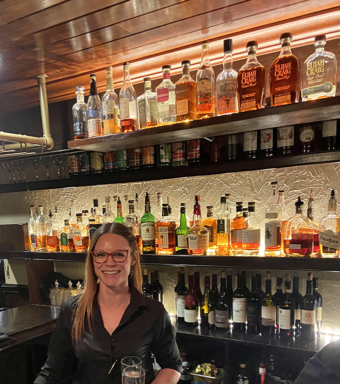 The bar area showcases a staff that knows your second drink before you've finished your first. That smile says "I've got recommendations that will change your life."