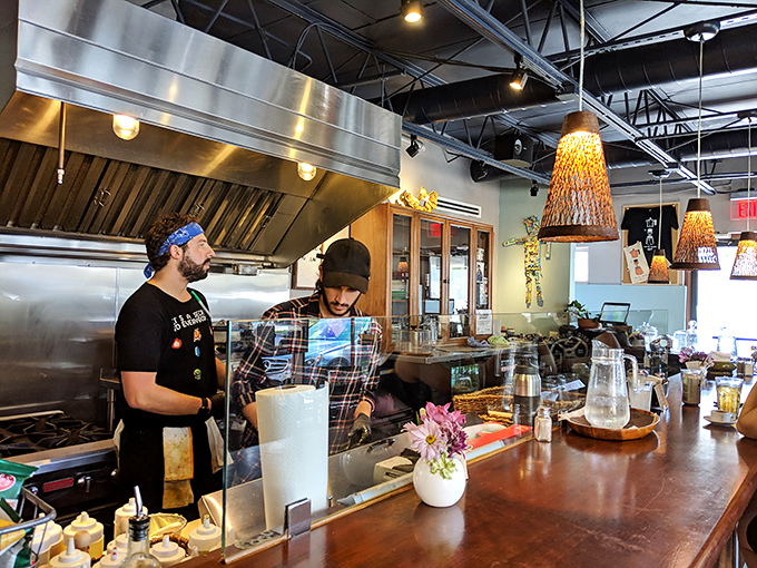 The kitchen crew works their magic behind the counter, creating the flavors that have made this Coral Gables spot a destination rather than just a caf&eacute;.