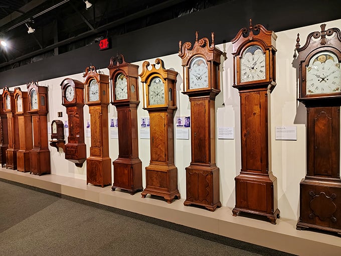 The grandfather clock lineup looks like a family reunion of tall, distinguished gentlemen, each trying to outdo the others with their fancy woodwork.