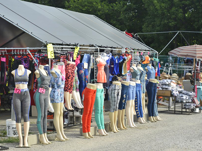 Mannequins stand at attention like fashion soldiers, their summer uniforms ready for inspection by bargain-hunting generals with discerning eyes.