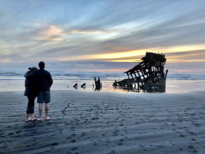 Twilight transforms the Peter Iredale into a brooding silhouette&mdash;part ghost ship, part photographer's dream, all Oregon coastal magic.