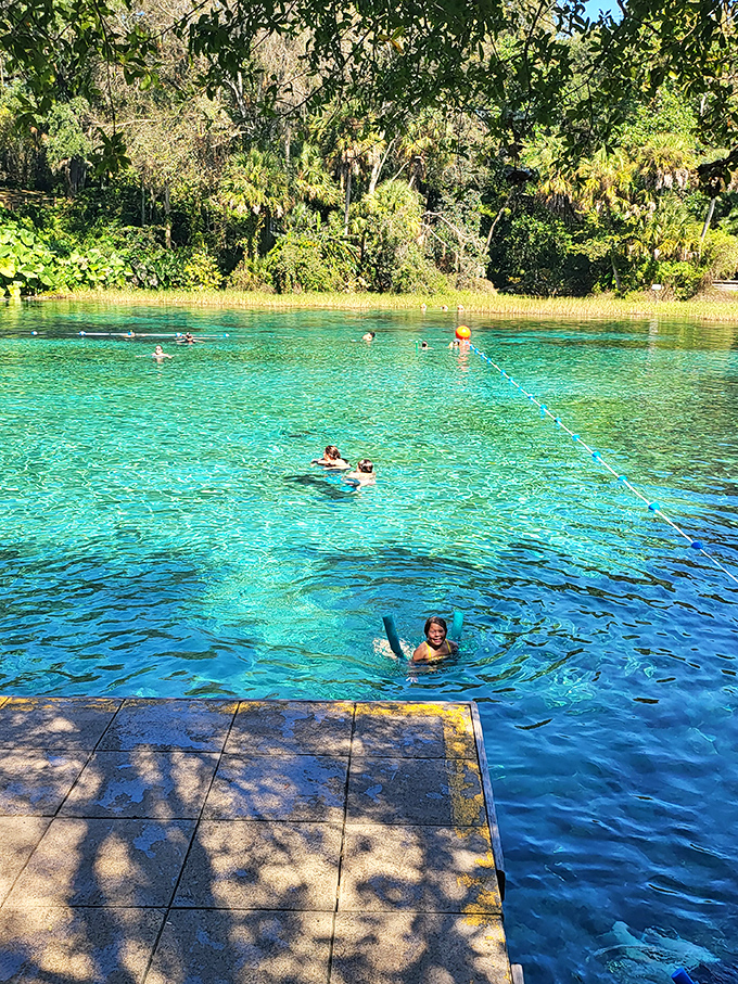 Swimmers float in water so transparent they appear to be levitating in liquid air.