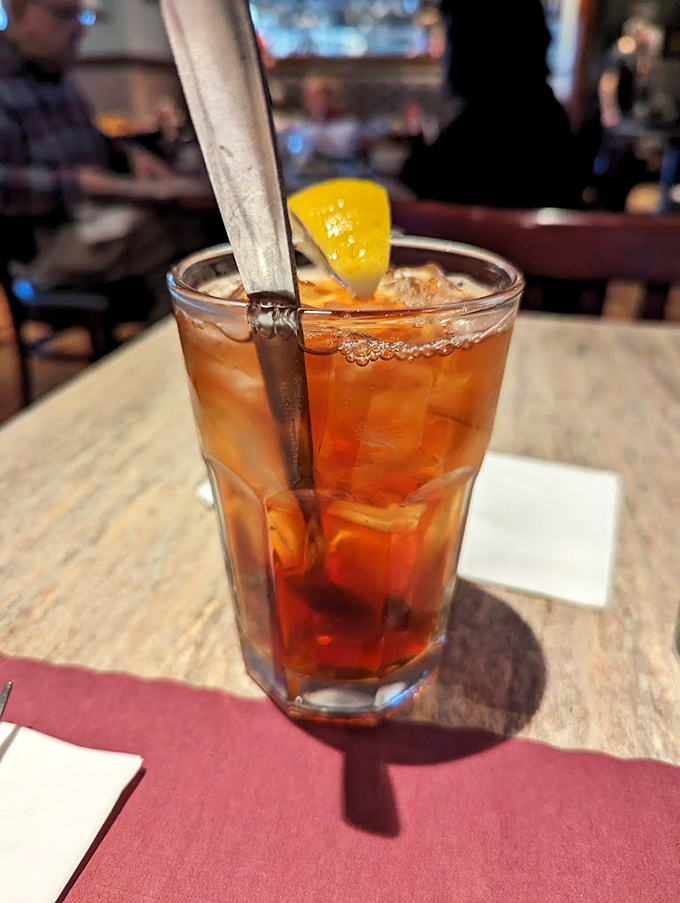 An amber-hued iced tea with a lemon wedge perched jauntily on the rim. The perfect companion for navigating a menu of endless possibilities.