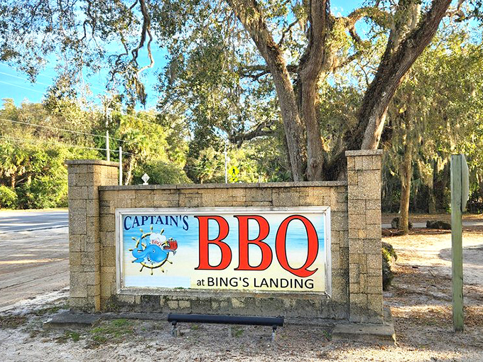 Captain's BBQ sign features a fish with tongs – because even seafood lovers know good barbecue when they smell it.
