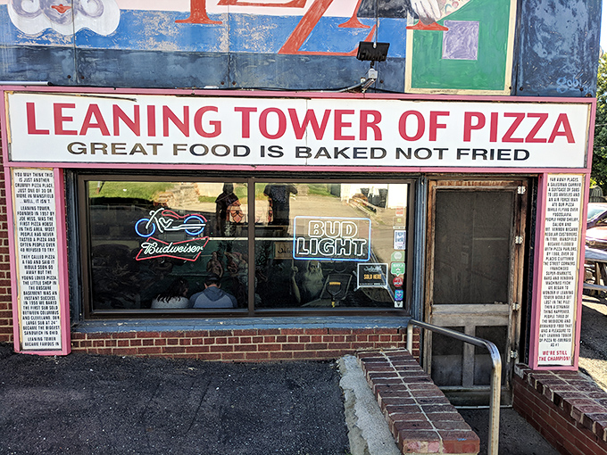 The weathered brick exterior tells stories of decades spent perfecting the art of pizza making.