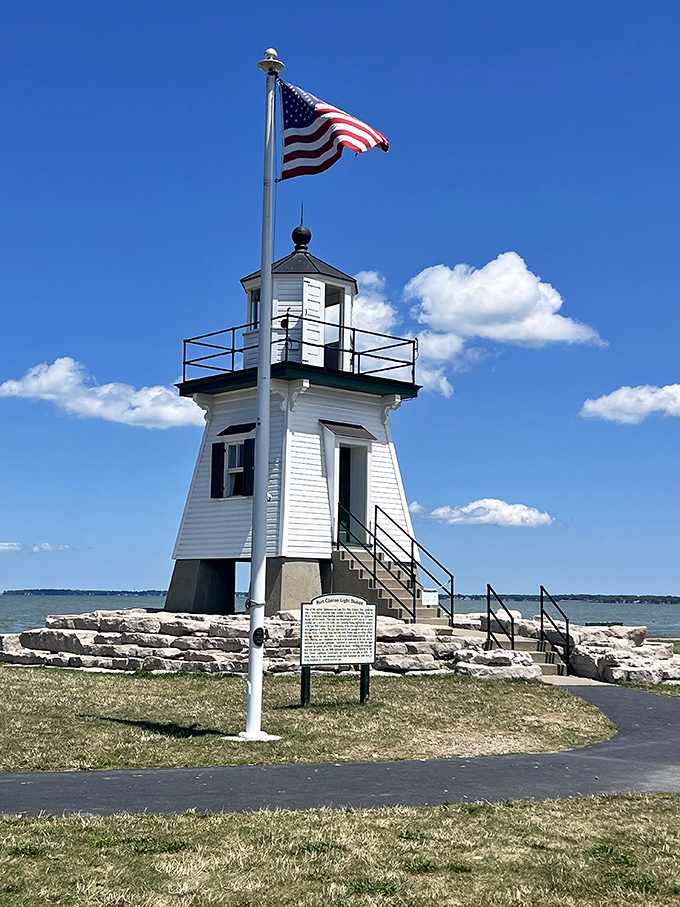 Port Clinton's wooden lighthouse stands like a friendly neighbor, flag waving hello to all who visit.