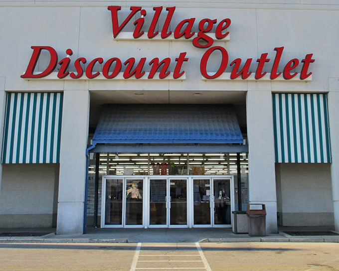 Village Discount Outlet's bold red lettering and blue awnings create a classic American shopping experience for thrift enthusiasts.