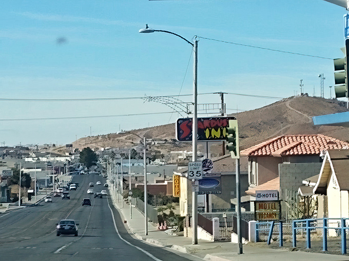 The desert horizon frames Barstow's main drag, where neon signs have welcomed weary travelers since the golden age of automobiles.