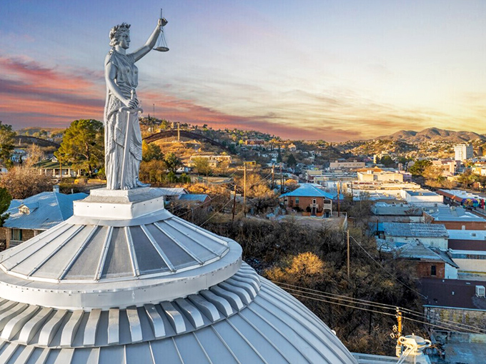 Nogales' skyline is crowned by Lady Justice, watching over this border town where two cultures blend seamlessly together.