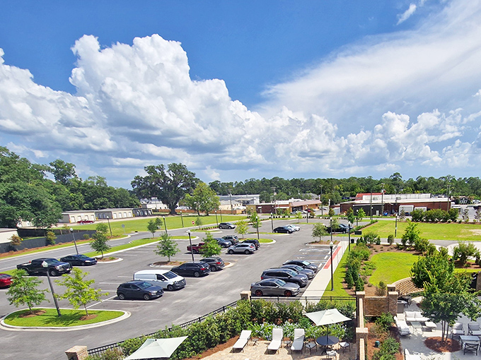 Downtown Thomasville unfolds in perfect Southern symmetry – where clouds and commerce create a postcard-worthy streetscape.
