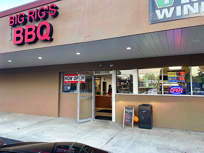 The bright red sign beckons like a lighthouse for the barbecue-starved, promising smoky salvation in an unassuming strip mall setting.