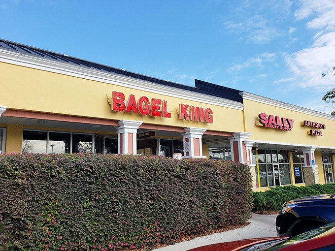 The bright red letters of Bagel King stand proud against the yellow facade, like a beacon calling hungry breakfast seekers home.