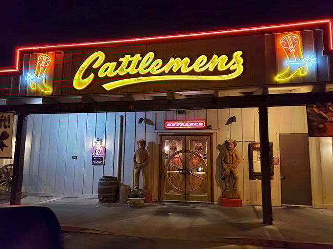 The neon cowboy boots flanking Cattlemens' sign aren't just decoration&mdash;they're beacons calling to hungry travelers like moths to a flame.