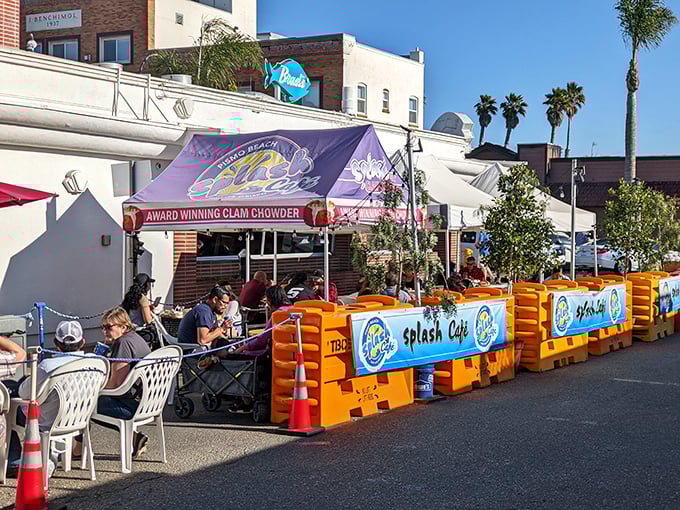 The outdoor seating area proves that paradise comes with a side of ocean breeze and purple awnings.