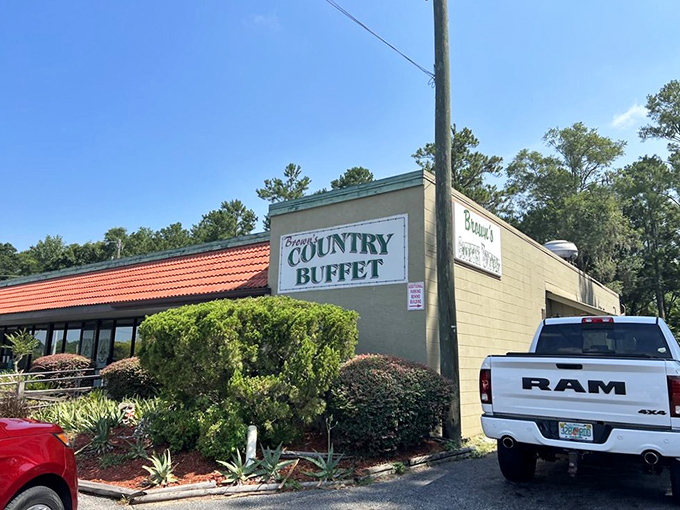 The unassuming exterior of Brown's Country Buffet stands like a beacon of hope for hungry travelers. That orange-tiled roof practically whispers, "Come get comfortable."