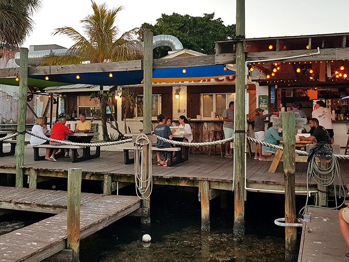 The ultimate Florida seafood experience awaits on this weathered dock where string lights twinkle above happy diners enjoying ocean-to-plate perfection.