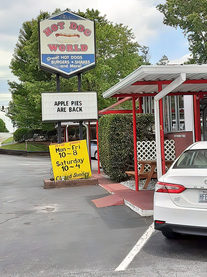 The iconic Hot Dog World sign stands like a beacon of comfort food joy, complete with red-trimmed awnings and the exciting news that "Apple Pies Are Back!"