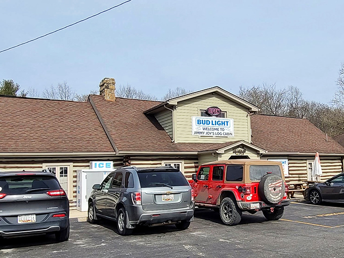 The rustic log cabin exterior isn't just charming&mdash;it's a siren call to hungry travelers. That parking lot tells the real story: people come from miles around.