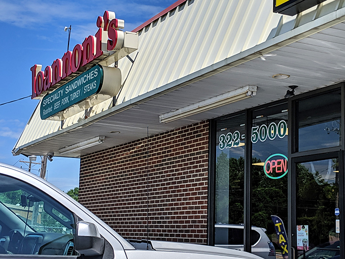 The iconic red sign beckons hungry travelers like a lighthouse for the sandwich-starved. This unassuming brick building houses Delaware's sandwich royalty.