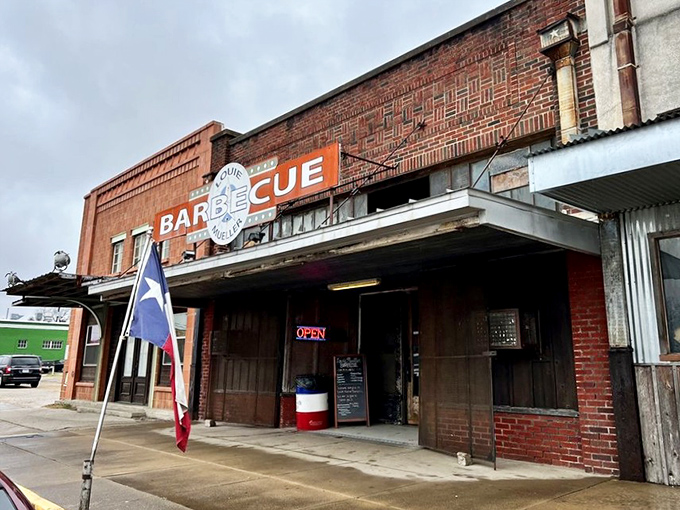 The brick facade of barbecue royalty stands proudly in Taylor, where that Texas flag and simple "BARBECUE" sign tell you everything you need to know.