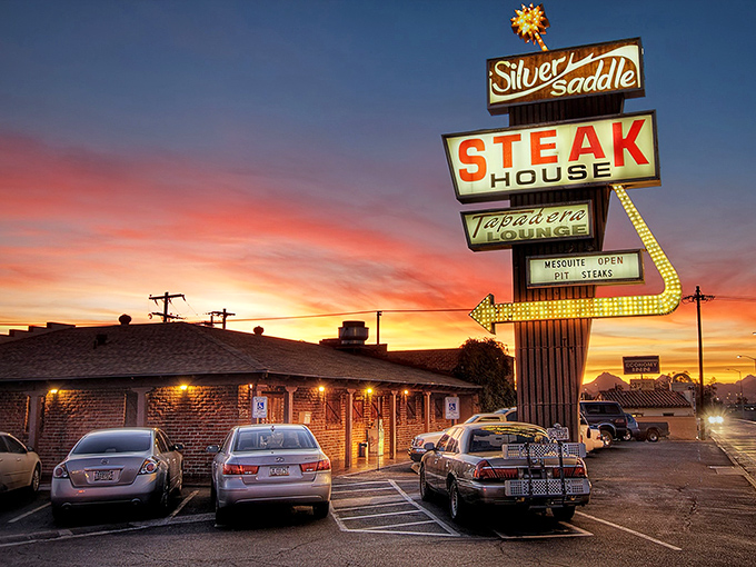 That vintage sign isn't just advertising &ndash; it's a time machine to when steakhouses were landmarks, not afterthoughts. The Silver Saddle stands proud against the Arizona sky.