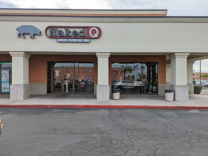 The blue pig silhouette beckons like a smoky siren call. NakedQ's unassuming strip mall exterior hides barbecue treasures that would make Texas weep with joy.