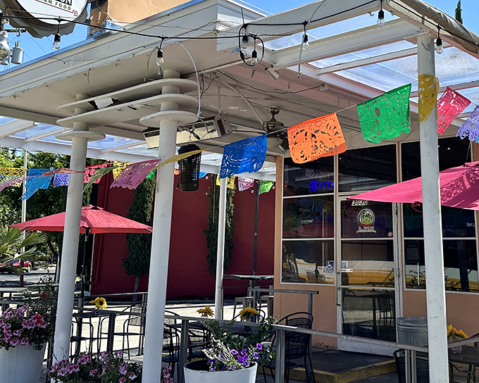 The colorful papel picado banners dancing above El Rincón's patio aren't just decoration—they're a promise that something worth celebrating awaits inside.